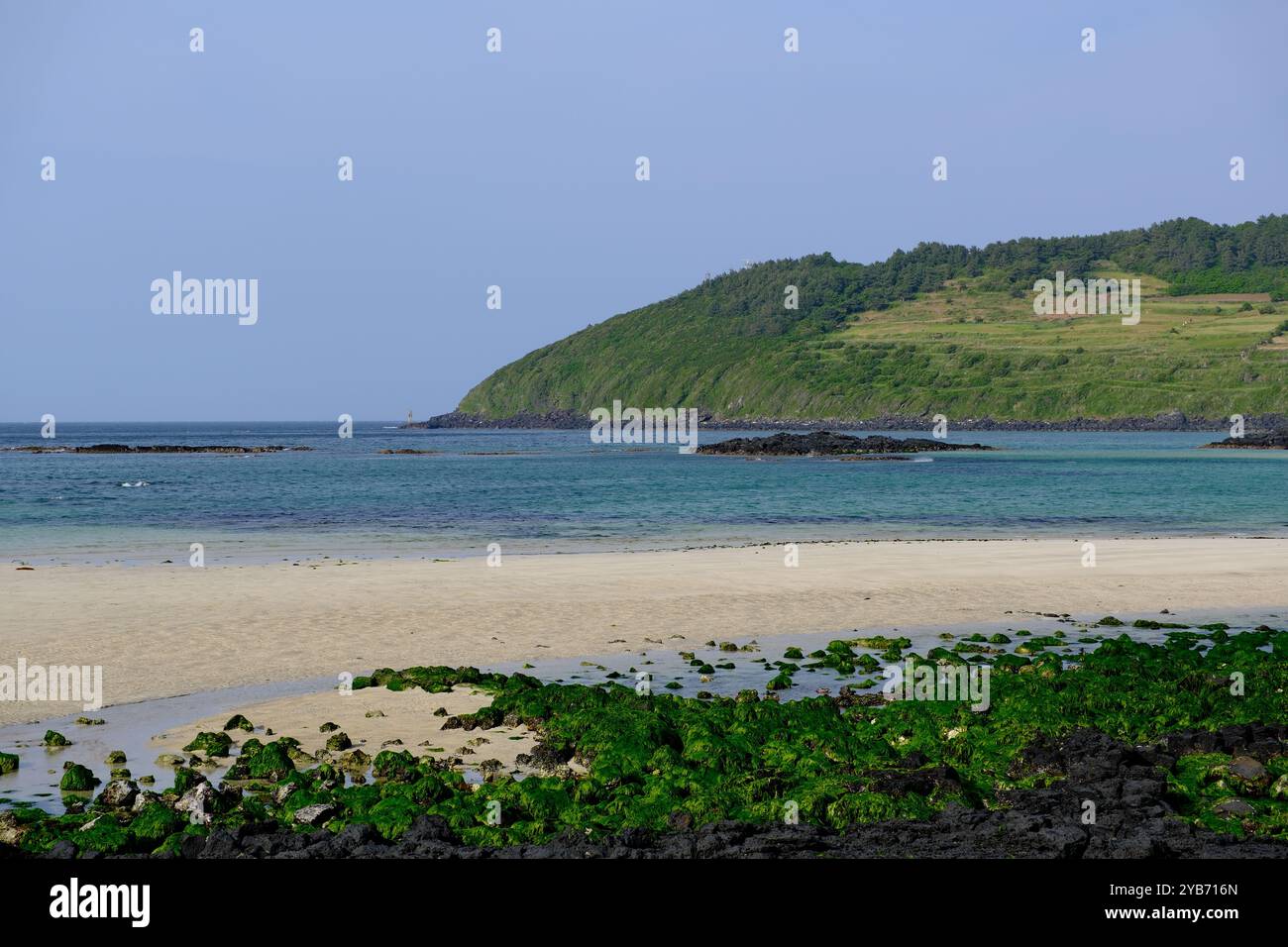 beautiful sand beach, blue sea and Seoubong peak in Jeju island, South ...