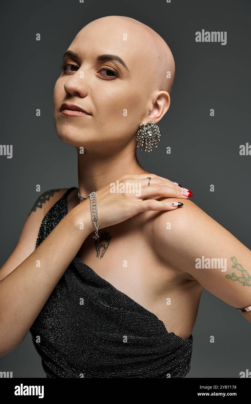 A young bald woman showcases her beauty, wearing elegant attire and ...
