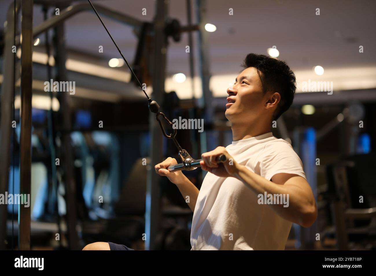 handsome Asian young man workout and exercise in gym. side view Stock ...