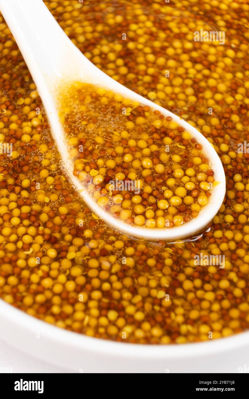 Traditional French Dijon mustard in a spoon on a white background Stock ...