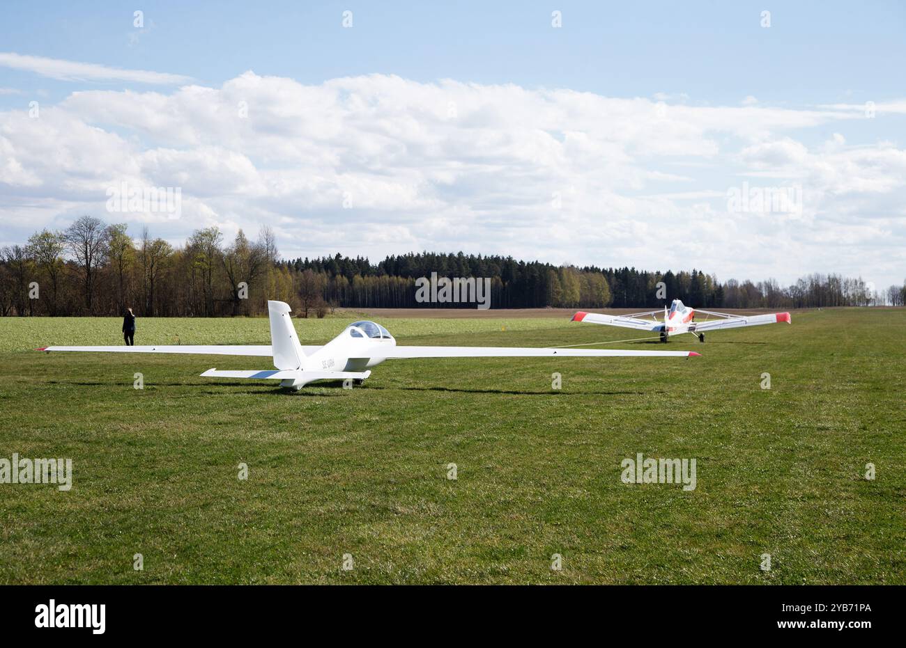 A glider is drawn up with a propeller plane on an airfield Stock Photo ...