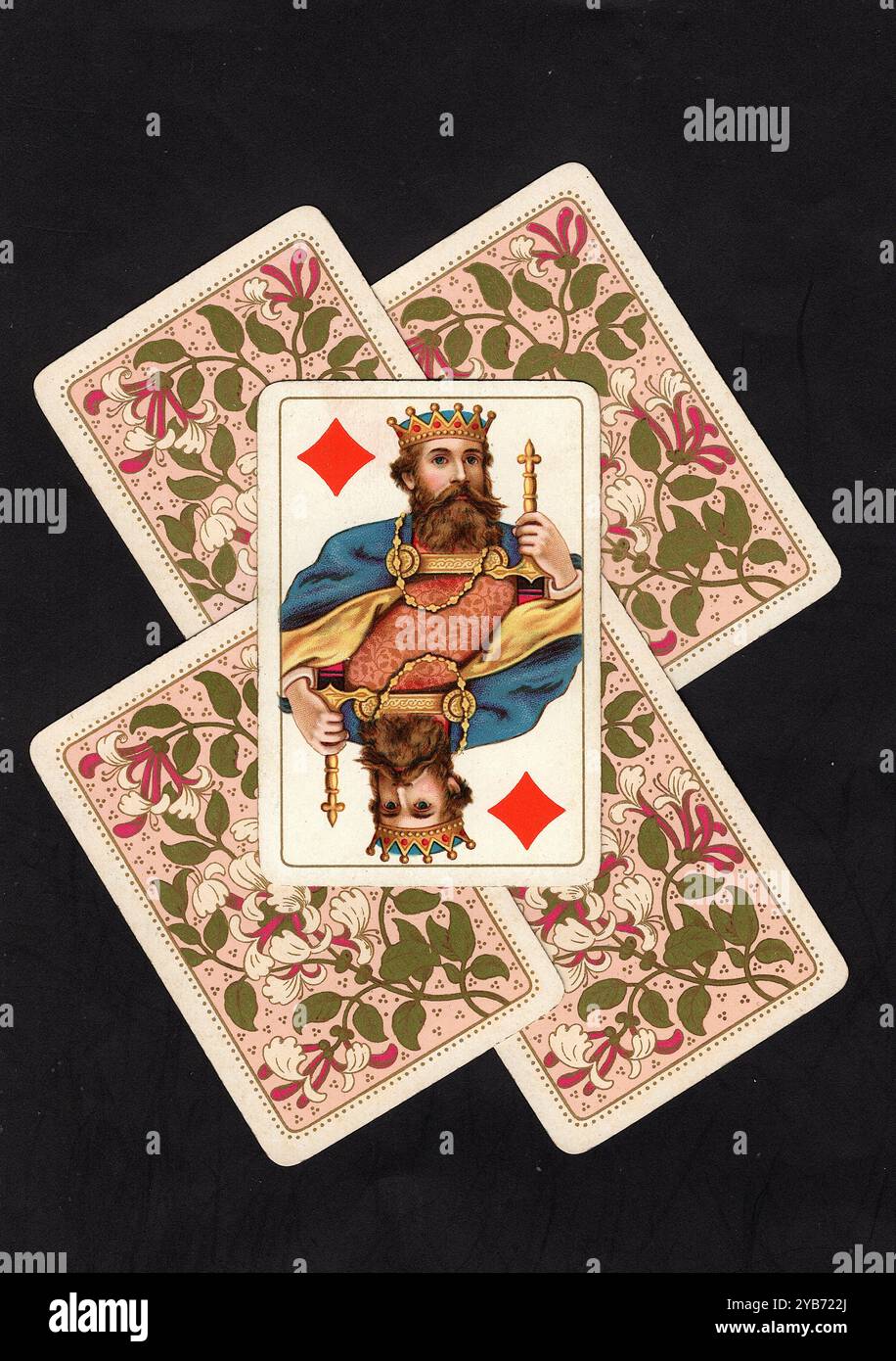 A montage of playing cards with one card revealed on a black background ...