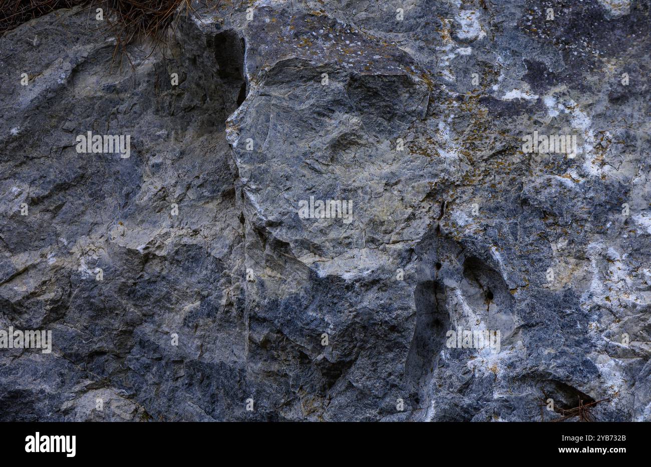 A rock formation exhibits shapes that resemble facial features ...