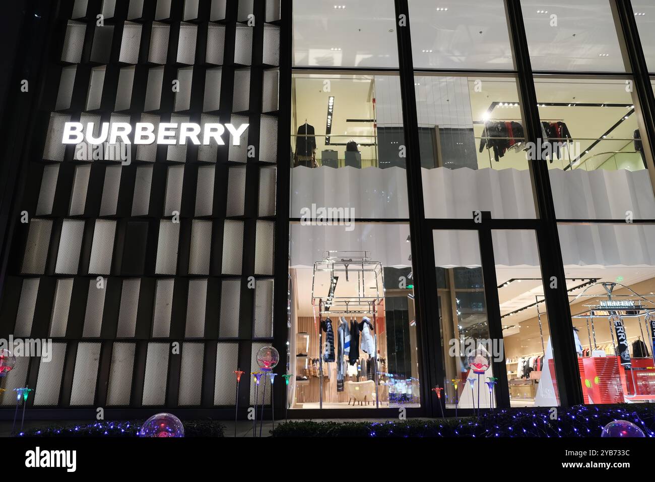 Shanghai,China-Dec.11th 2022: facade of large Burberry retail flagship store at night. British ...