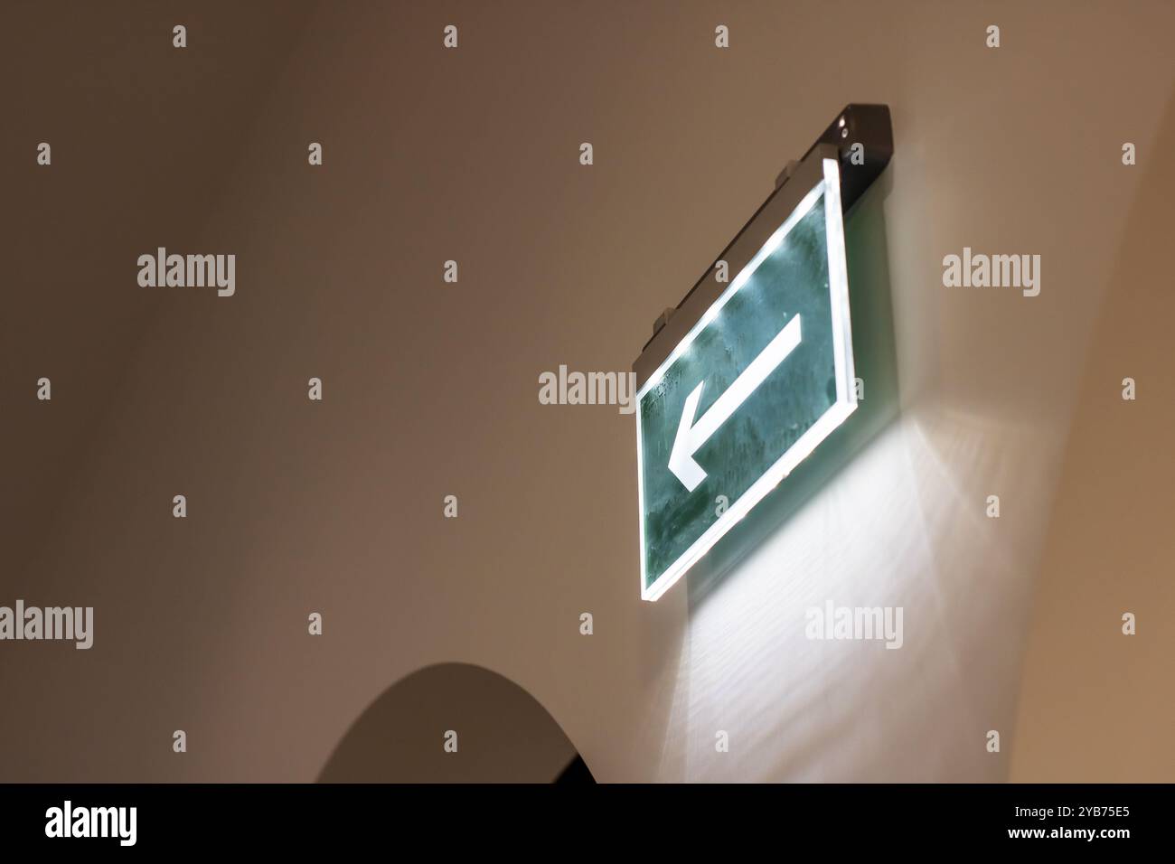 There is a bright green exit sign that features an arrow distinctly ...