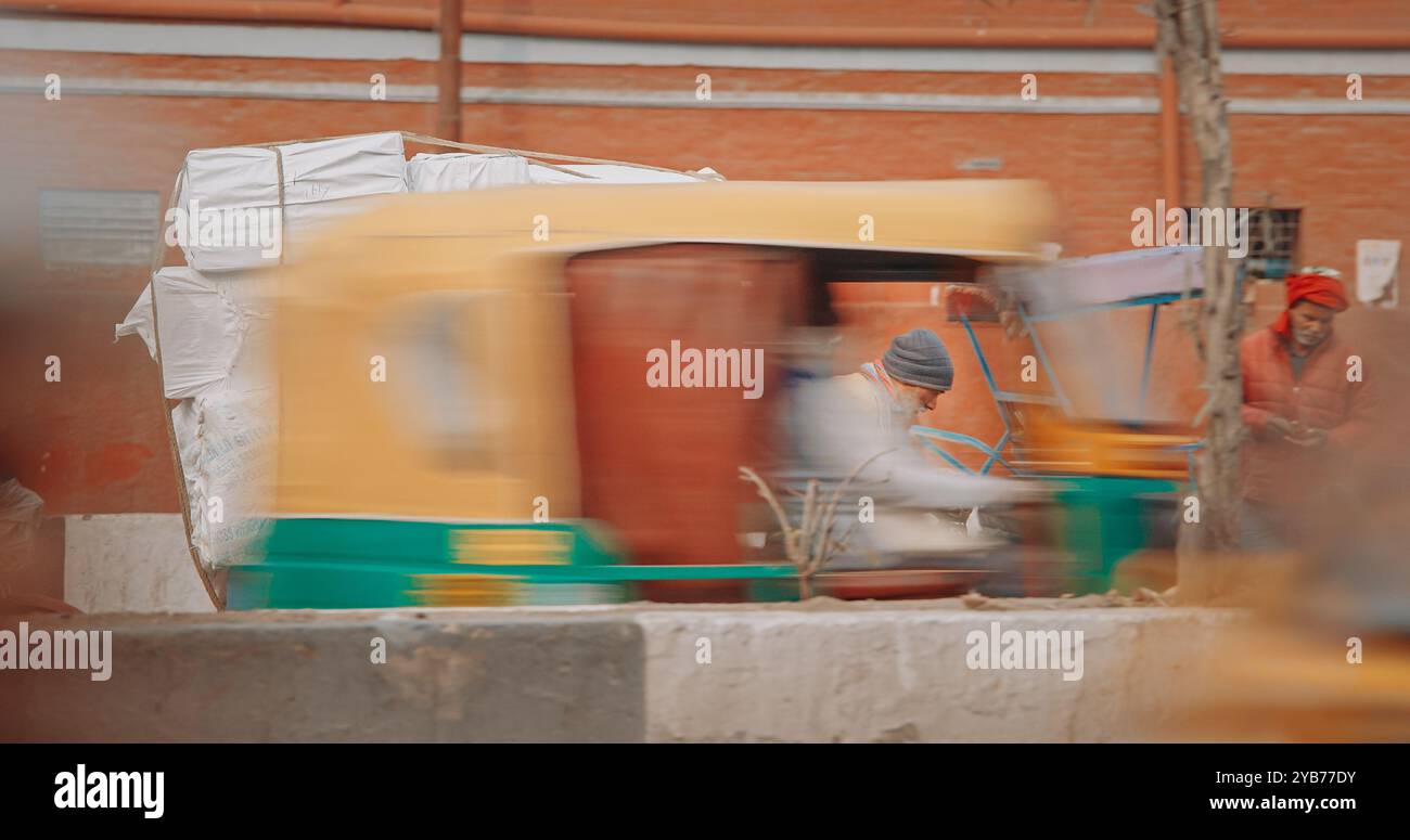 New Delhi, Delhi, India. Indian man carries loaded cargo on a cargo ...