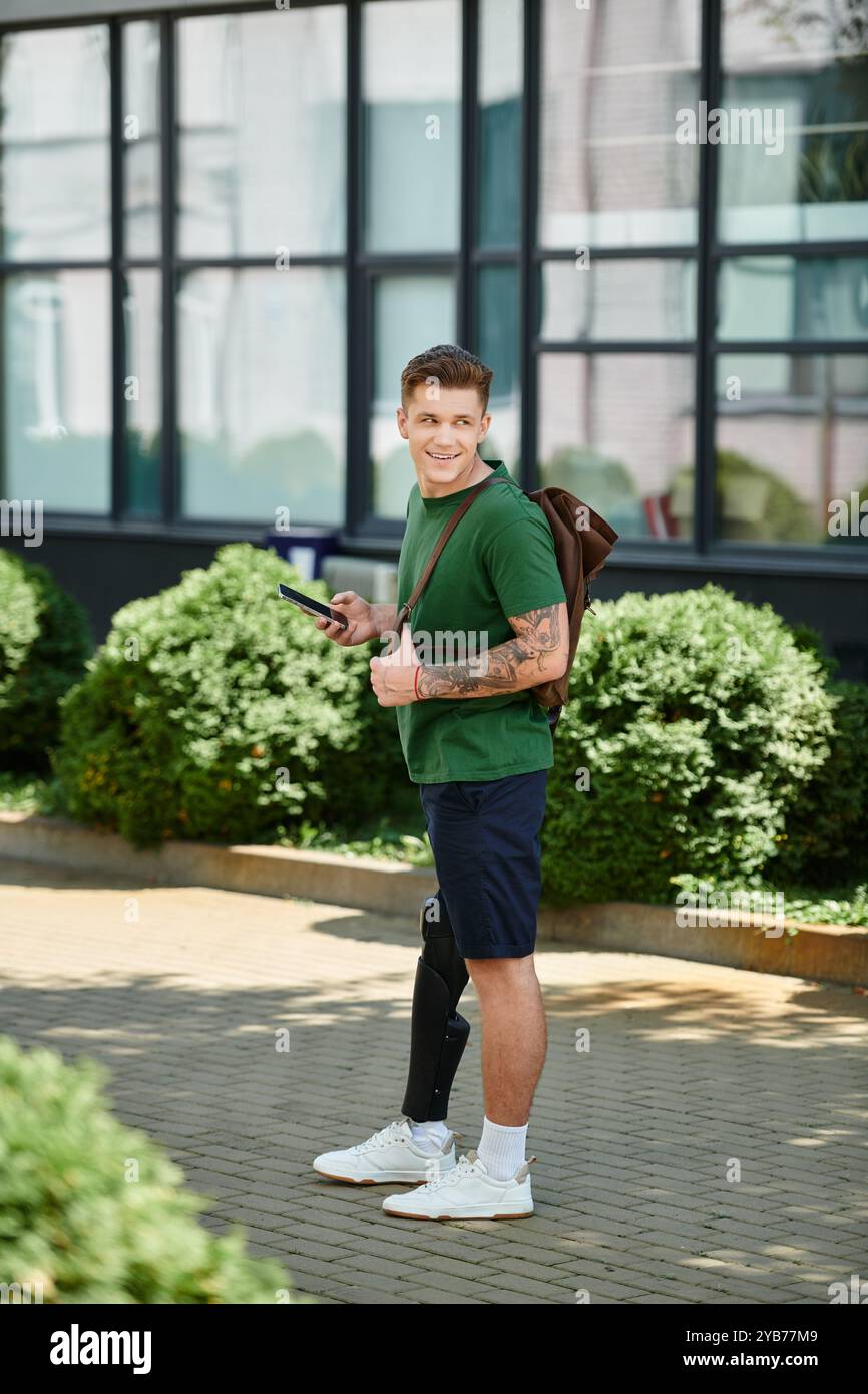 A handsome young man stands outside, confidently displaying his ...