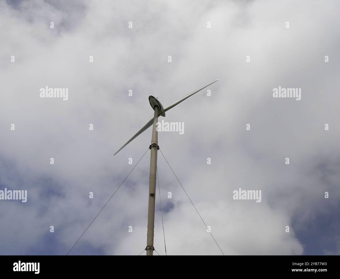 two blade wind turbine and cloudy sky, wind power and clean energy ...