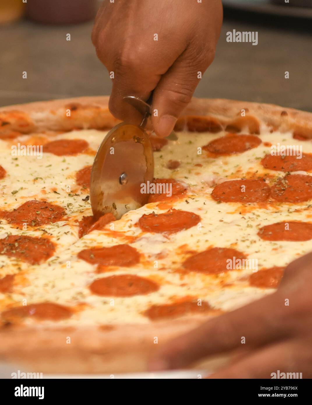 Italian thin crust pizza with spicy salami and mozzarella Stock Photo ...