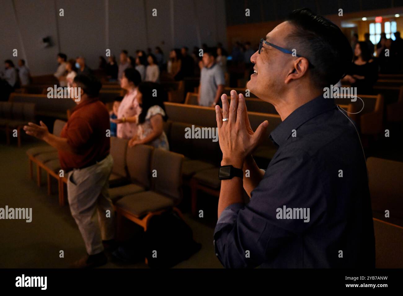 Pastor Owen Lee prays during a service at the Christ Central ...