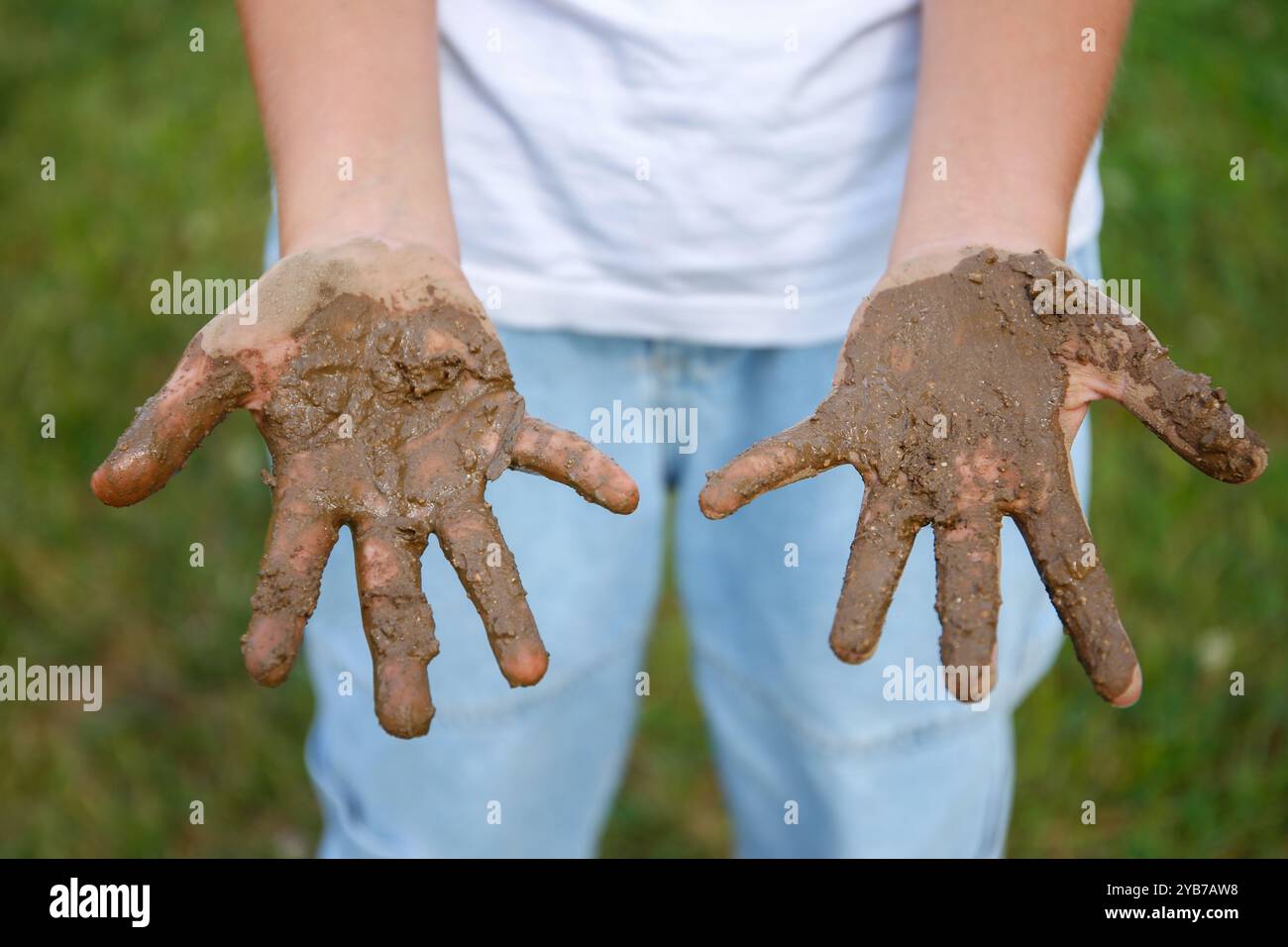 The child shows his hands in the dirt Stock Photo - Alamy
