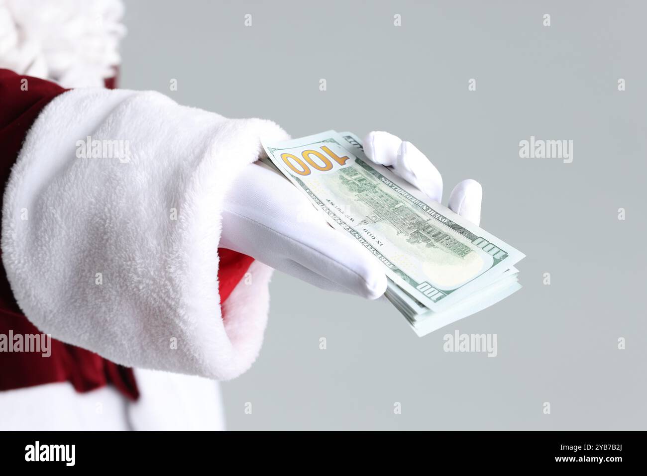 Santa Claus holding dollar banknotes on gray background, closeup Stock ...