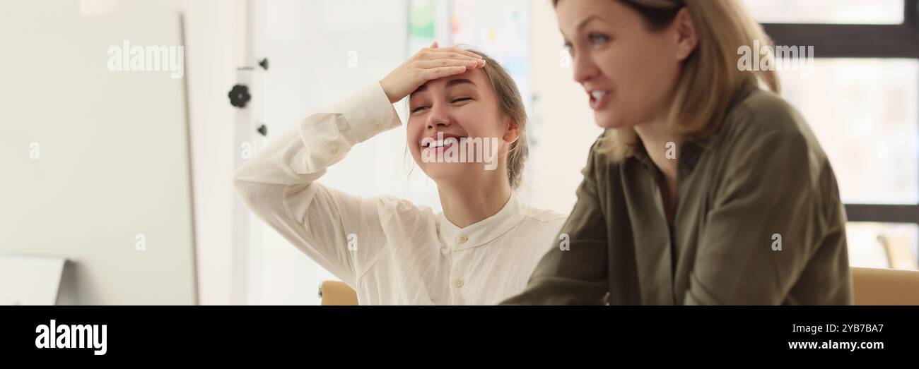 Cheerful women smile looking at screen of computer monitor Stock Photo ...