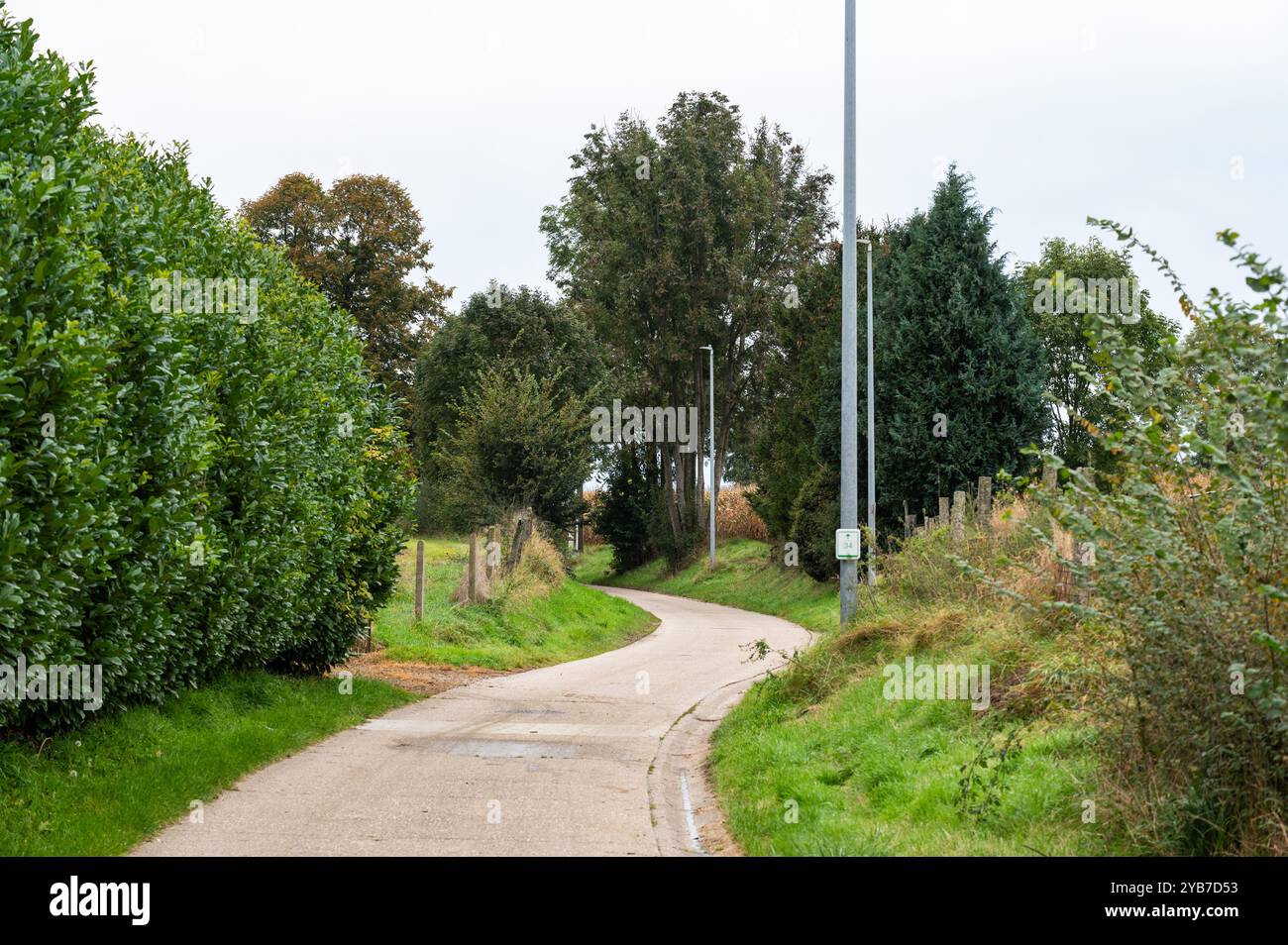 Bending country road through the countryside in the village of ...