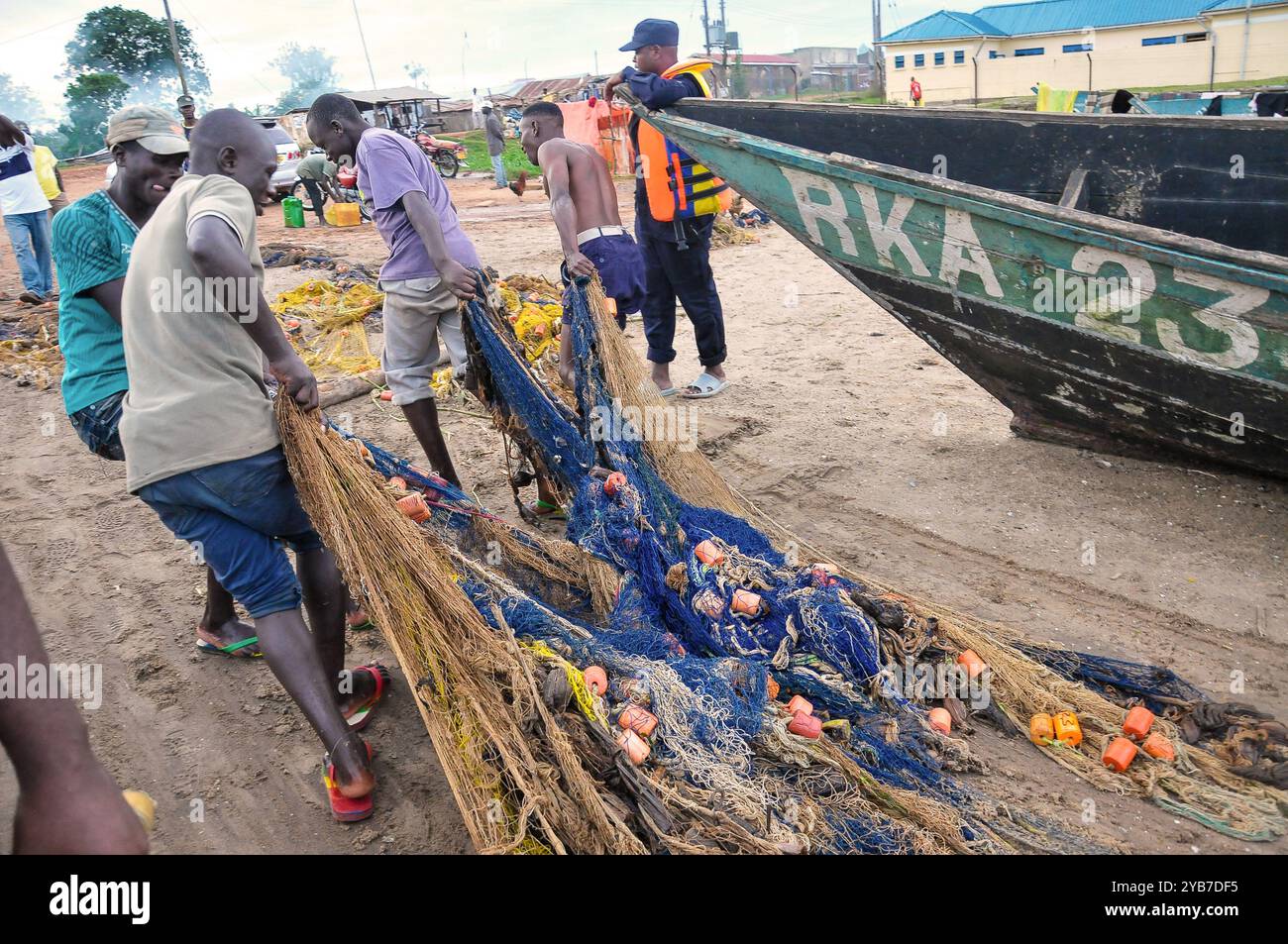 Fishermen pulling their nets at Kasensero fish landing site on Lake ...
