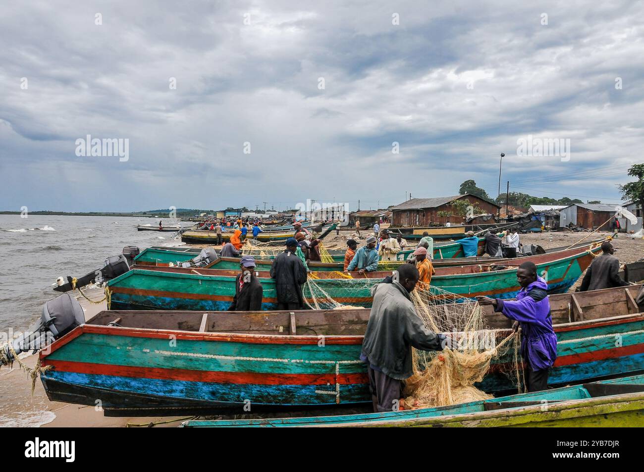 Fishermen sorting fishing nets at Kasensero fish landing site on Lake ...