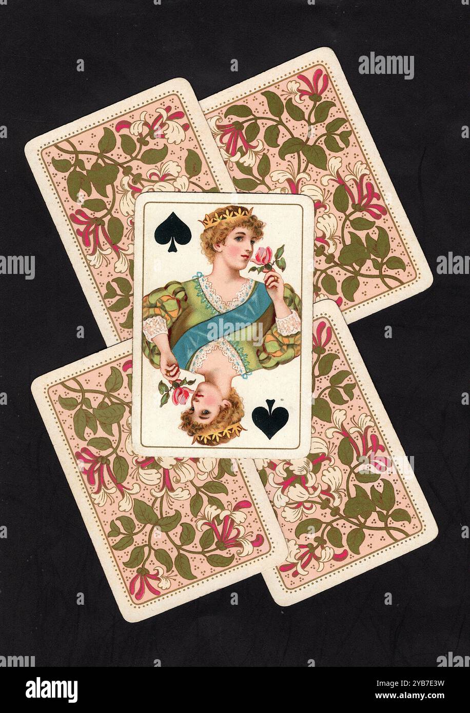 A montage of playing cards with one card revealed on a black background ...