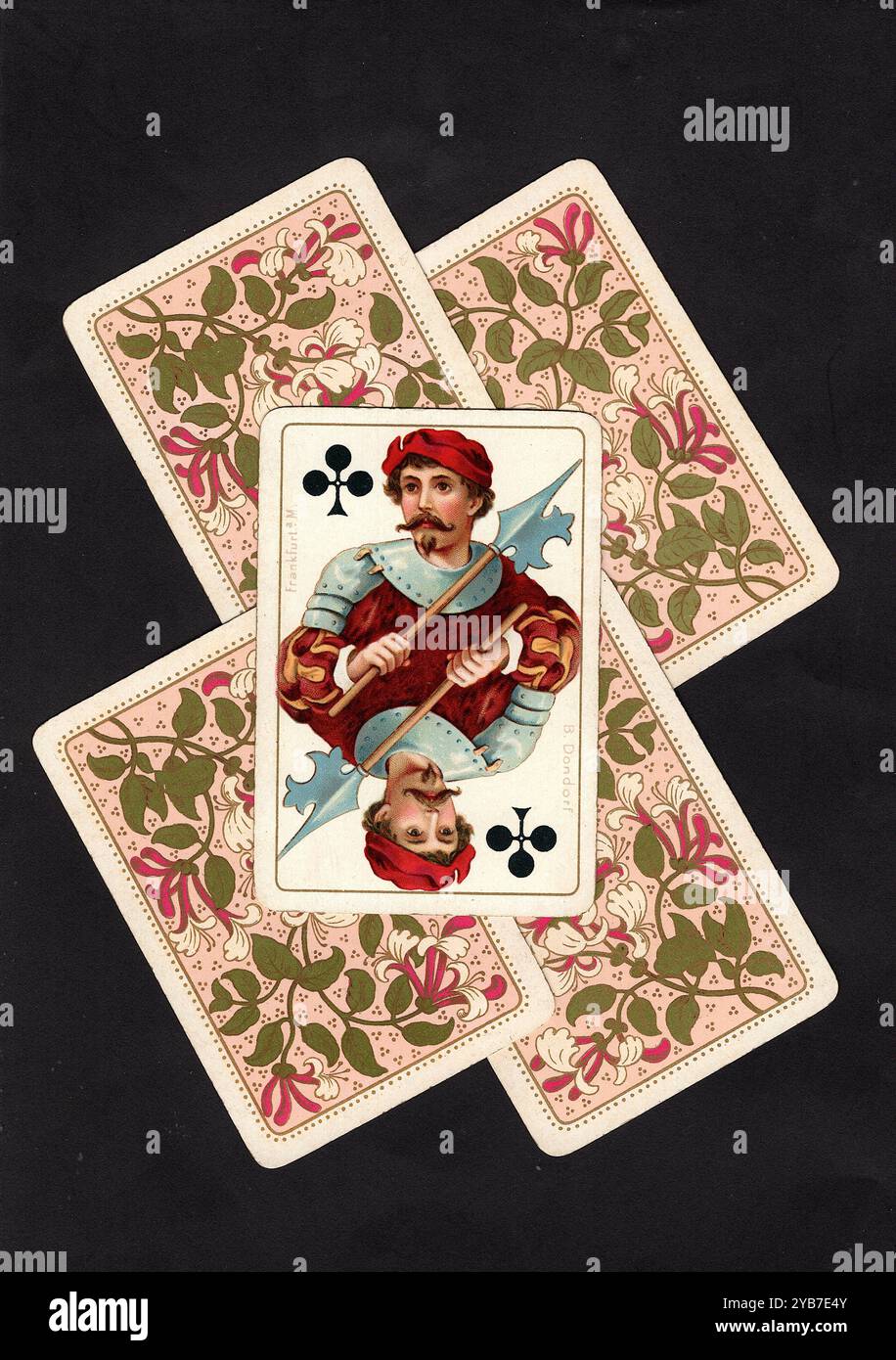 A montage of playing cards with one card revealed on a black background ...