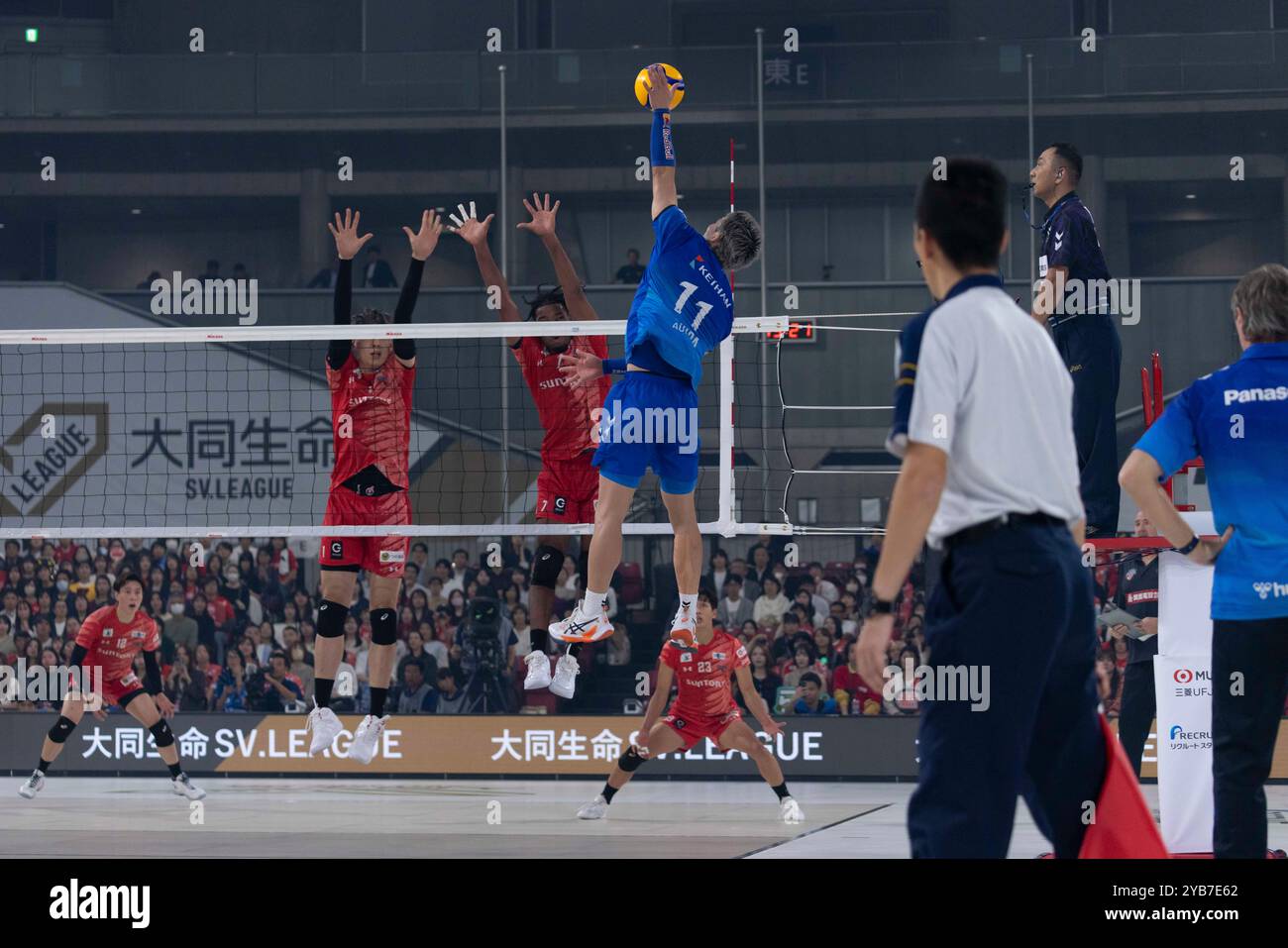 Yuji Nishida (11 OP) from the Osaka Bluteon makes a hit over the net ...