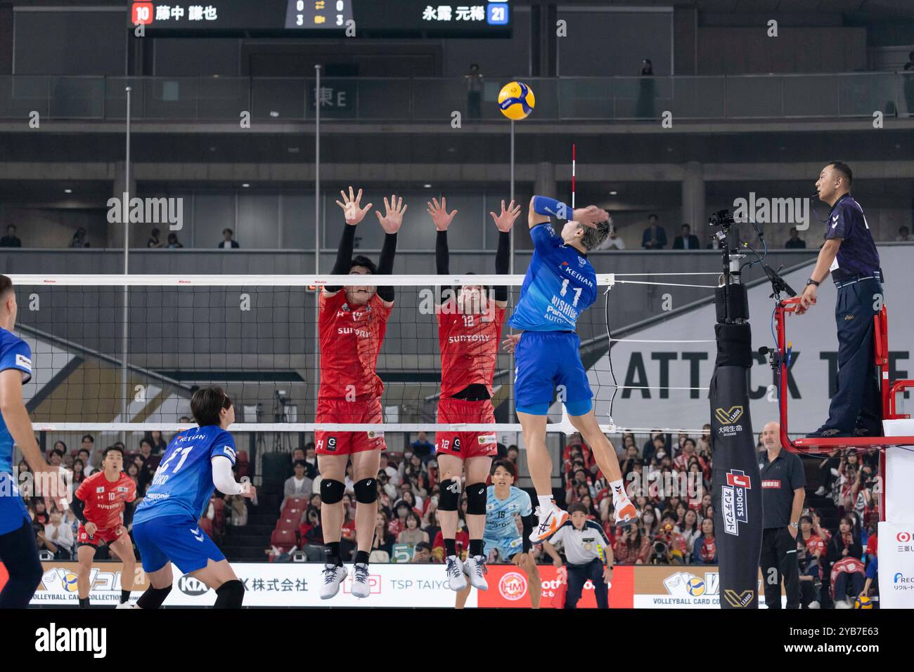 Yuji Nishida (11 OP) from the Osaka Bluteon makes a hit over the net ...