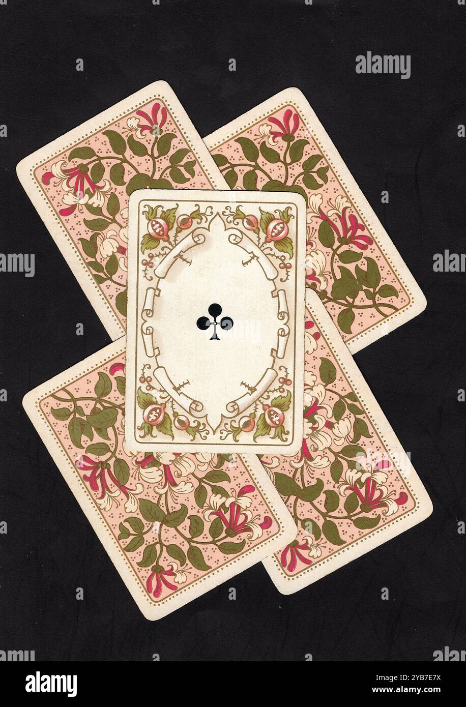 A montage of playing cards with one card revealed on a black background ...