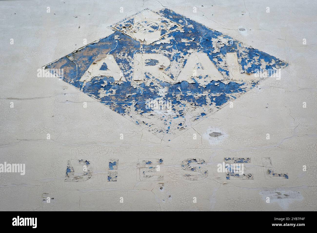 The weathered logo of the mineral oil company ARAL on a house wall in ...