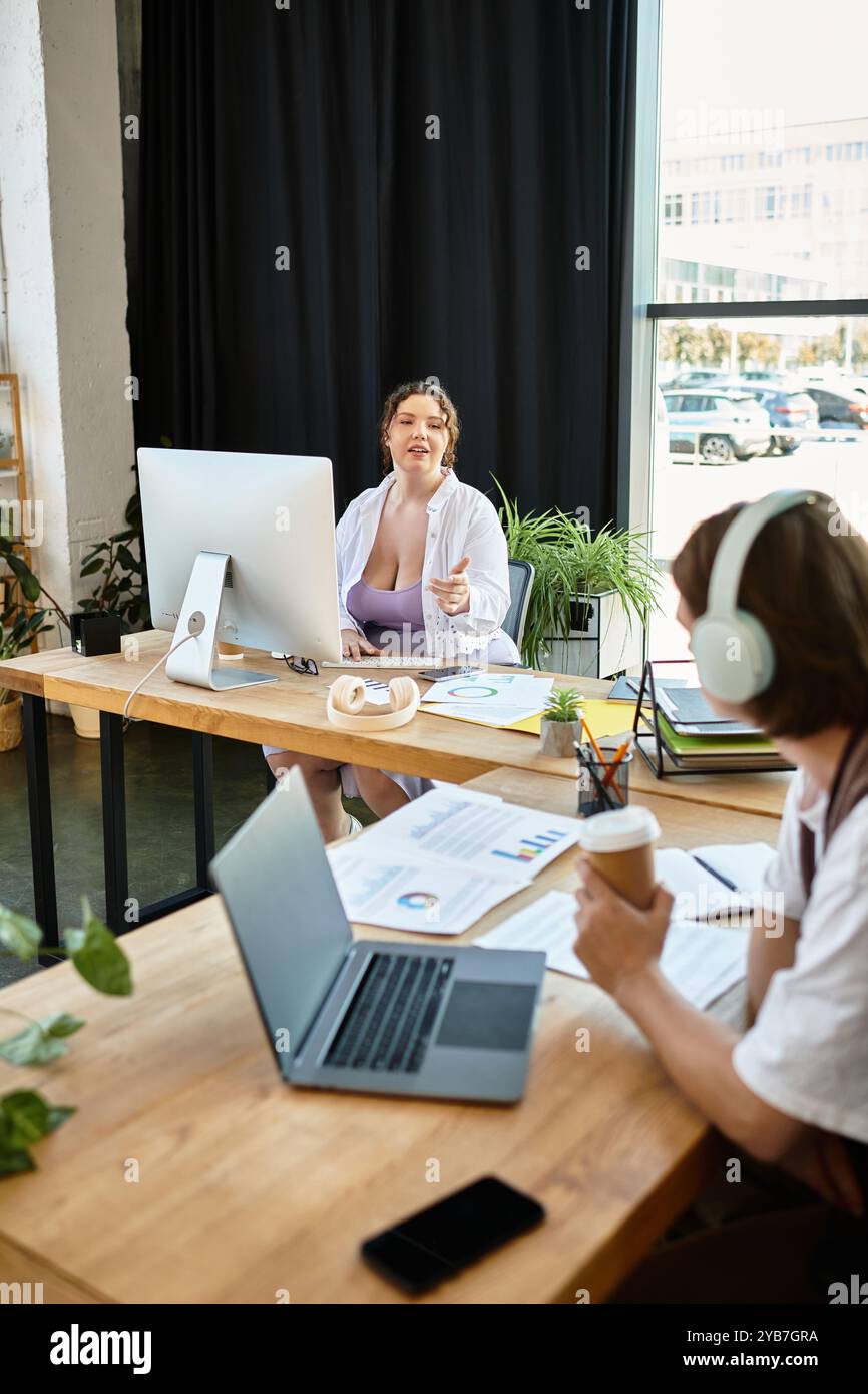 A plus size woman and her male friend engage in an animated discussion ...