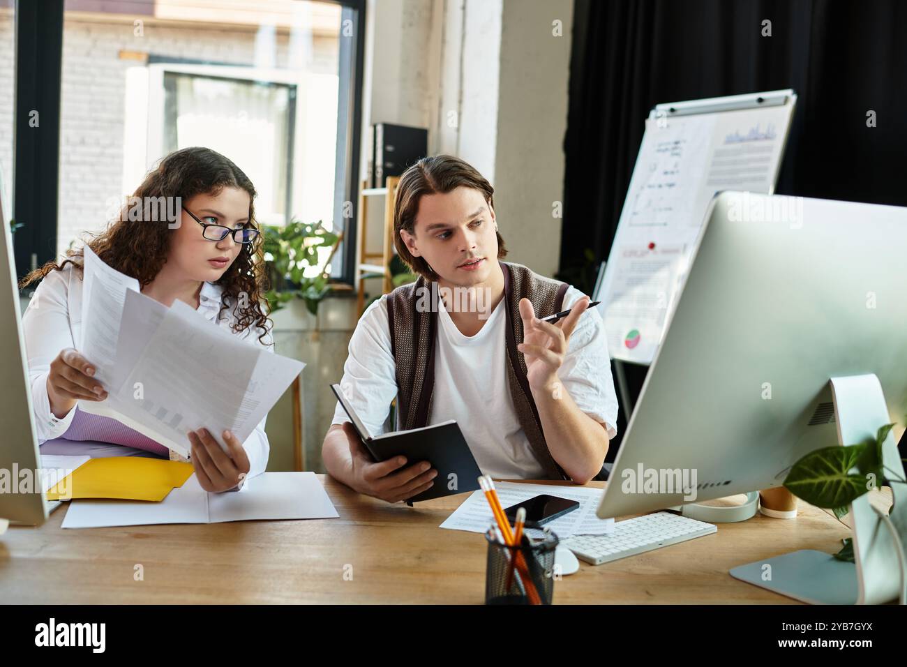 A young plus size woman and her male friend engage in a lively ...