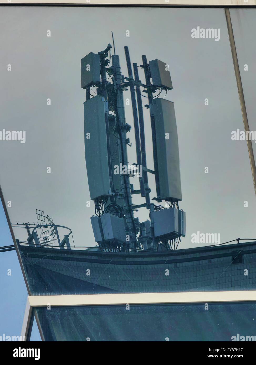 Reflection in Glass: 5G Cell Tower in the Window Frame Stock Photo - Alamy