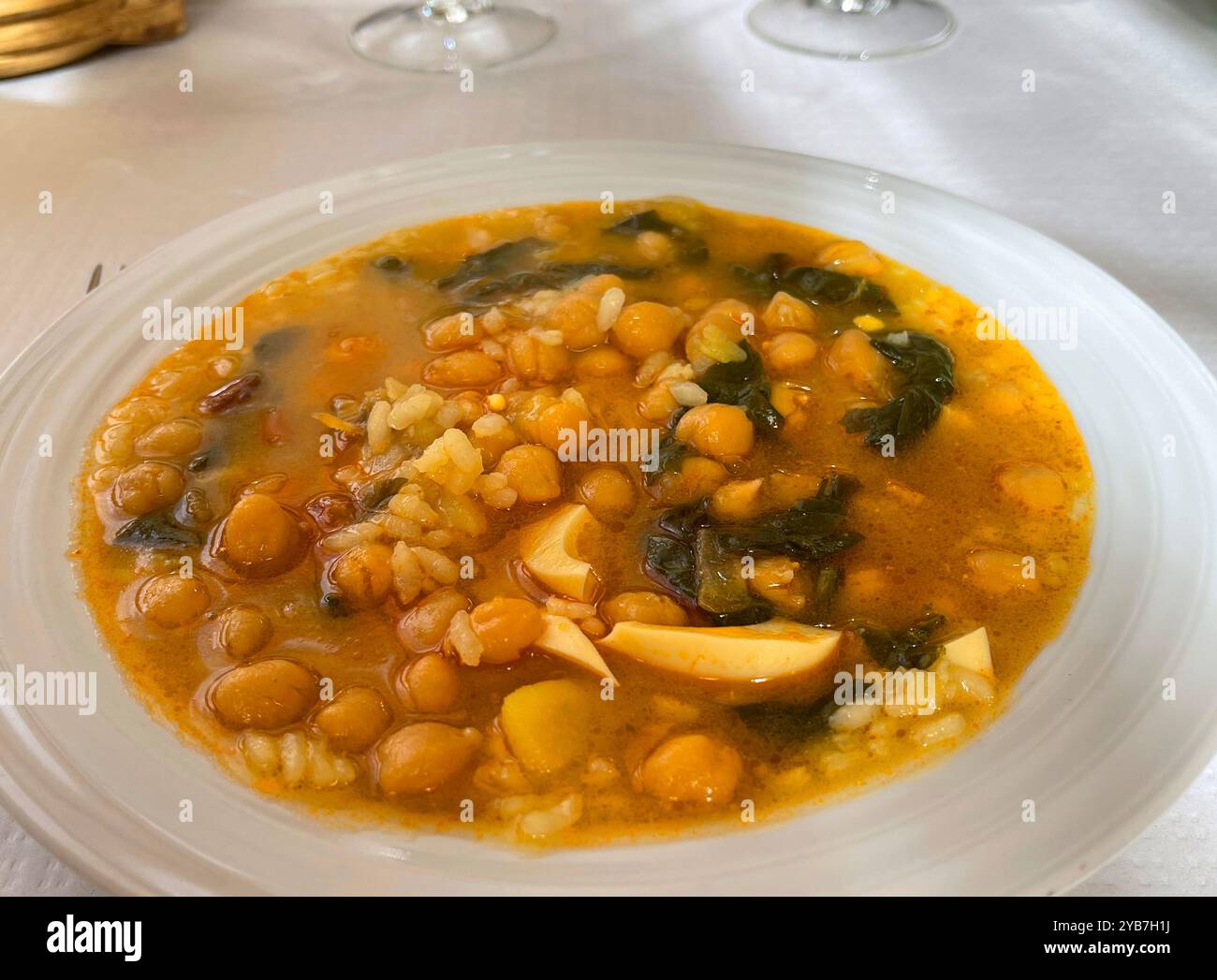 Potaje, traditional chickpeas stew with rice, spinach, cod and egg ...