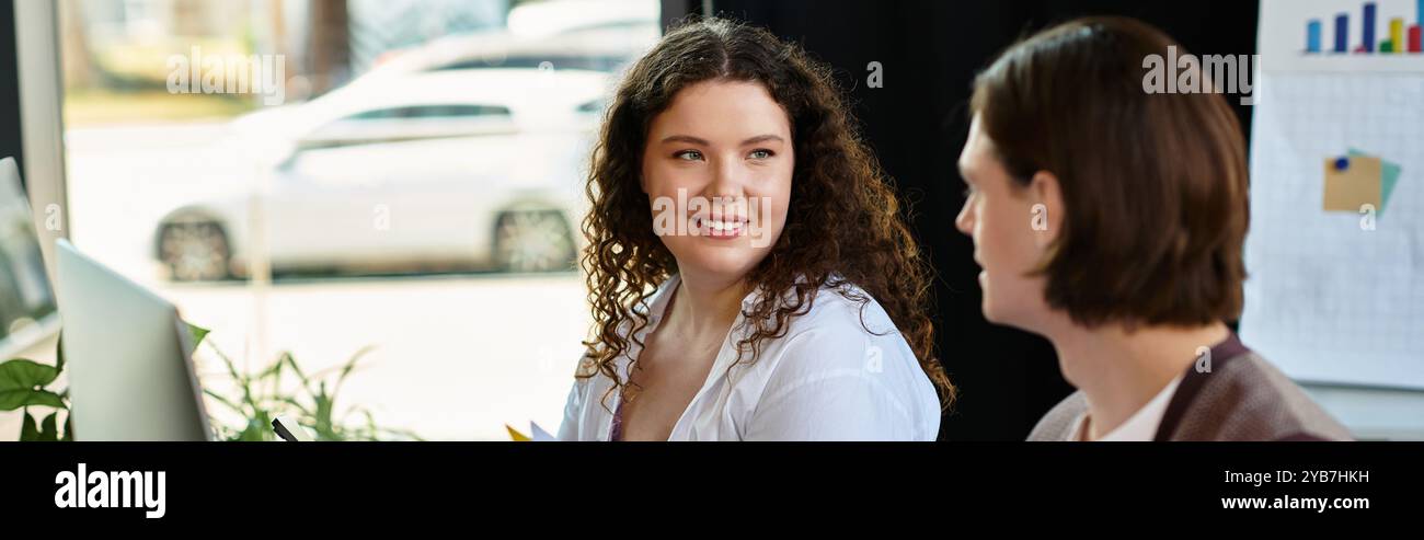 The young woman shares a smile while chatting with her male friend over ...
