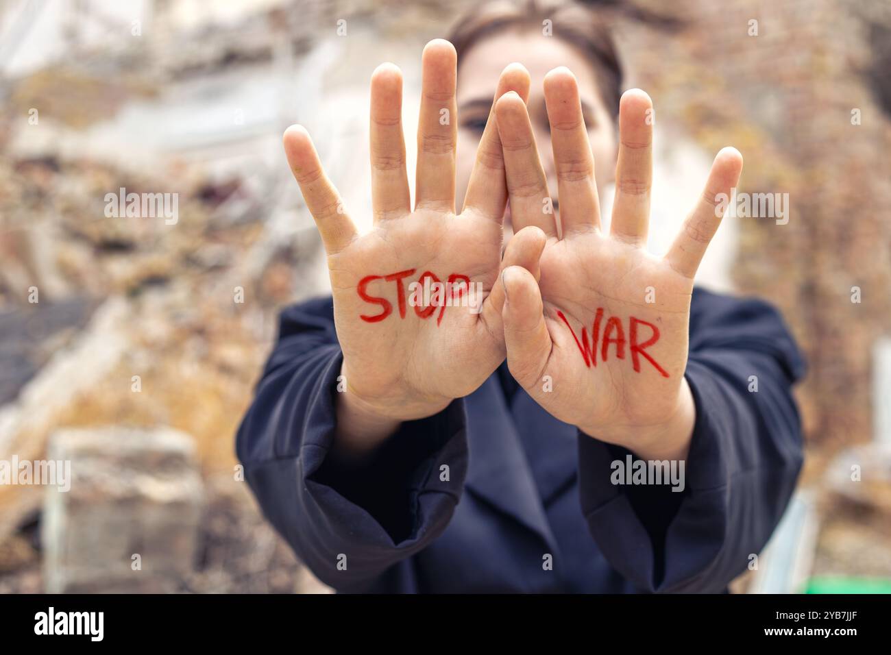 Slogan of peace without war is written on the woman's hand in red stop ...