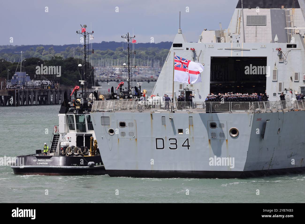 Sailors line the deck of the destroyer HMS DIAMOND on its return from a ...