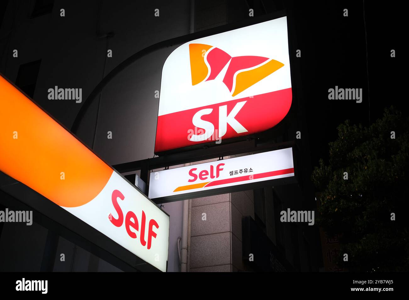 Jeju, South Korea-May 23rd 2024: SK Self gas station brand logo sign at night Stock Photo - Alamy