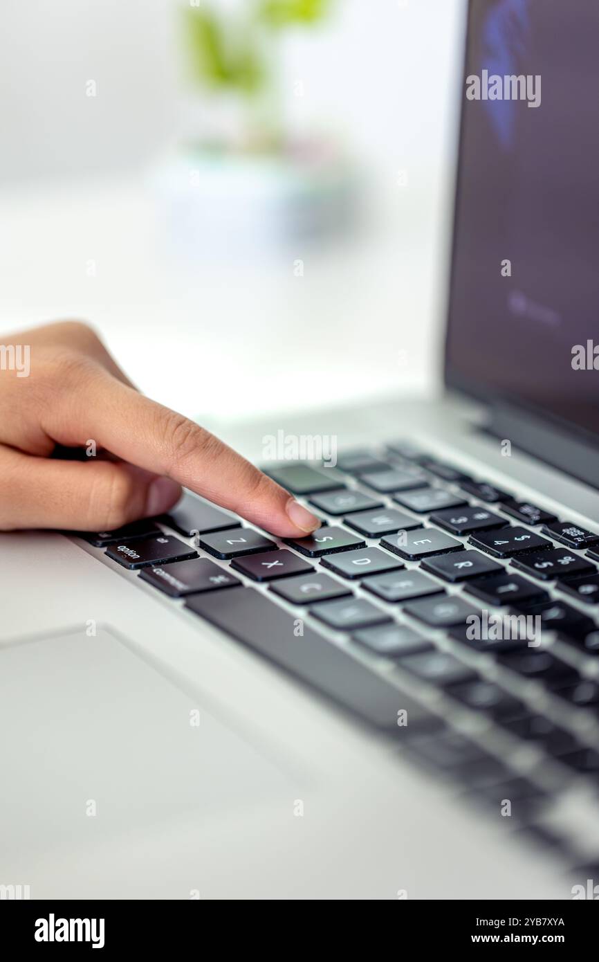 The girl is typing on the laptop keyboard. Girl's hands on the keyboard ...