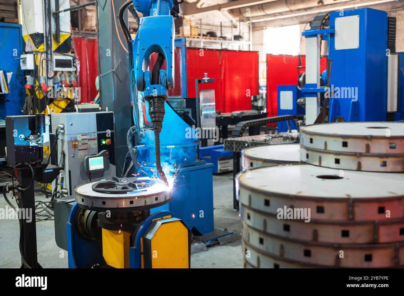 Automatic Industrial welding robot in a modern factory in operation ...