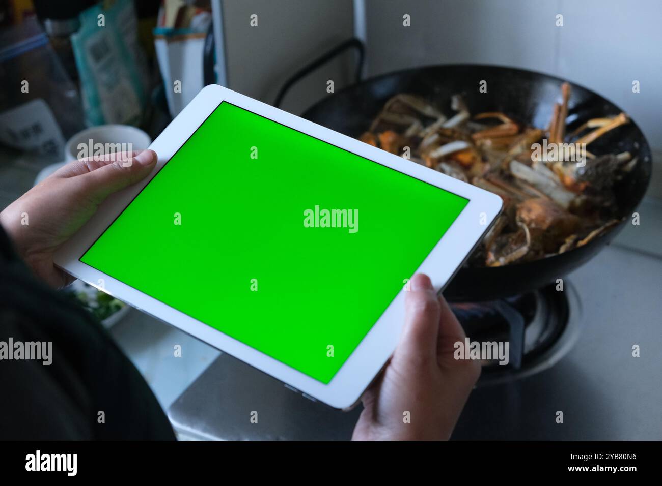 hand hold green screen tablet when cooking Stock Photo - Alamy