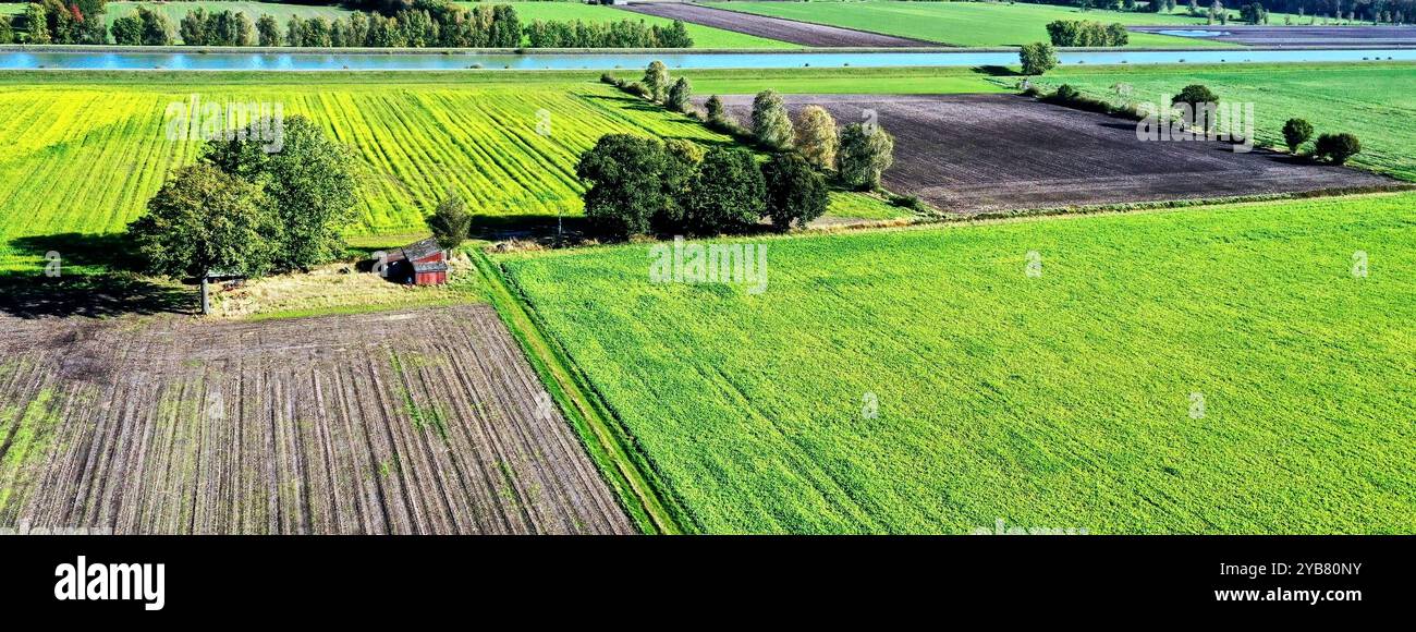Aerial view of a canal flowing through farmland in germany, showcasing ...