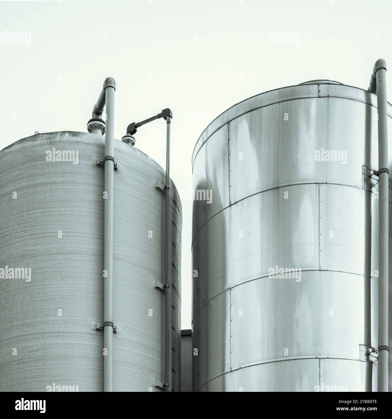 Two silos, one shiny and one opaque from a chemical industry plant ...