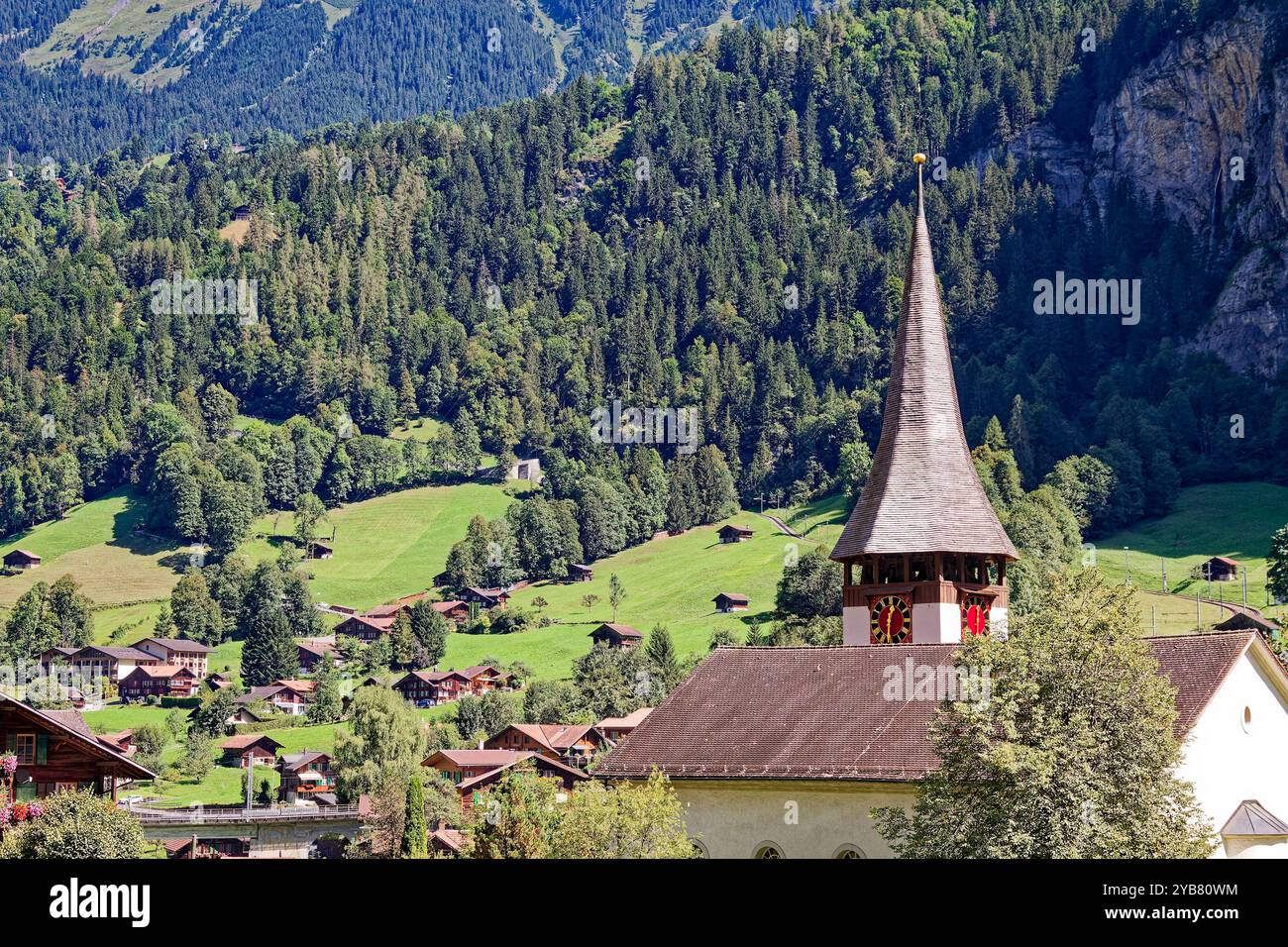 Alpine village scene, church steeple, houses, mountain, green trees ...