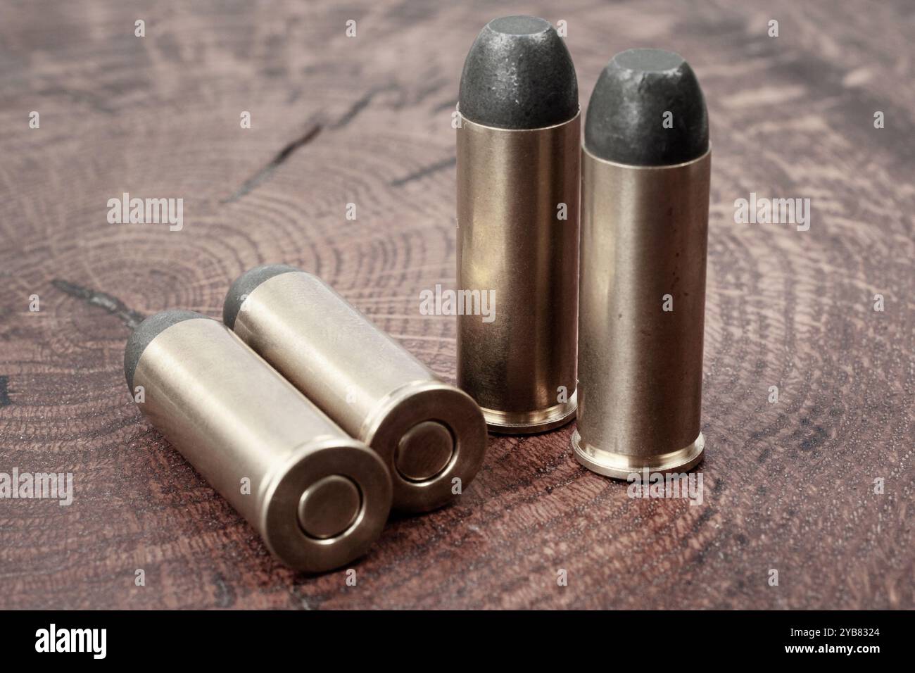 Old West era Long Colt .45 caliber revolver cartridges on a wooden table Stock Photo - Alamy