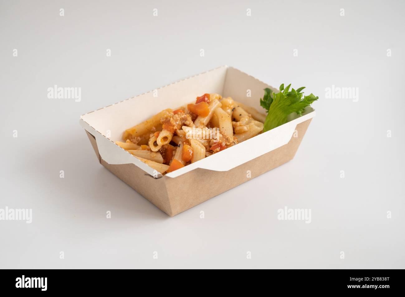 Four takeout meals served in biodegradable containers, featuring pasta ...