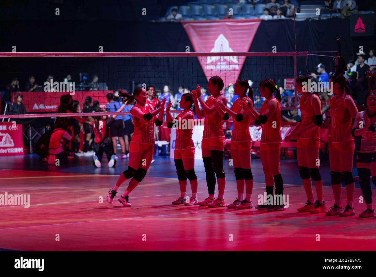 Team members of NEC Red Rockets Kawasaki greet each other before the opening match of Daido Life ...