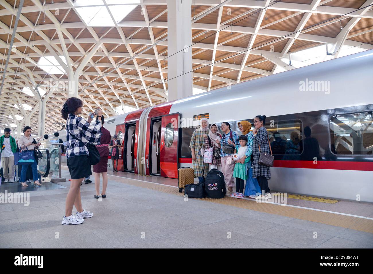 Jakarta, Indonesia. 17th Apr, 2024. Passengers pose for photos with a high-speed electrical ...
