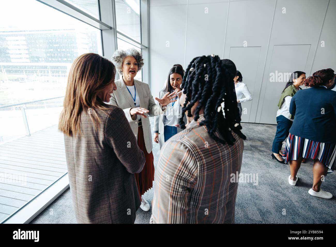 Diverse group of business professionals networking and engaging at a ...