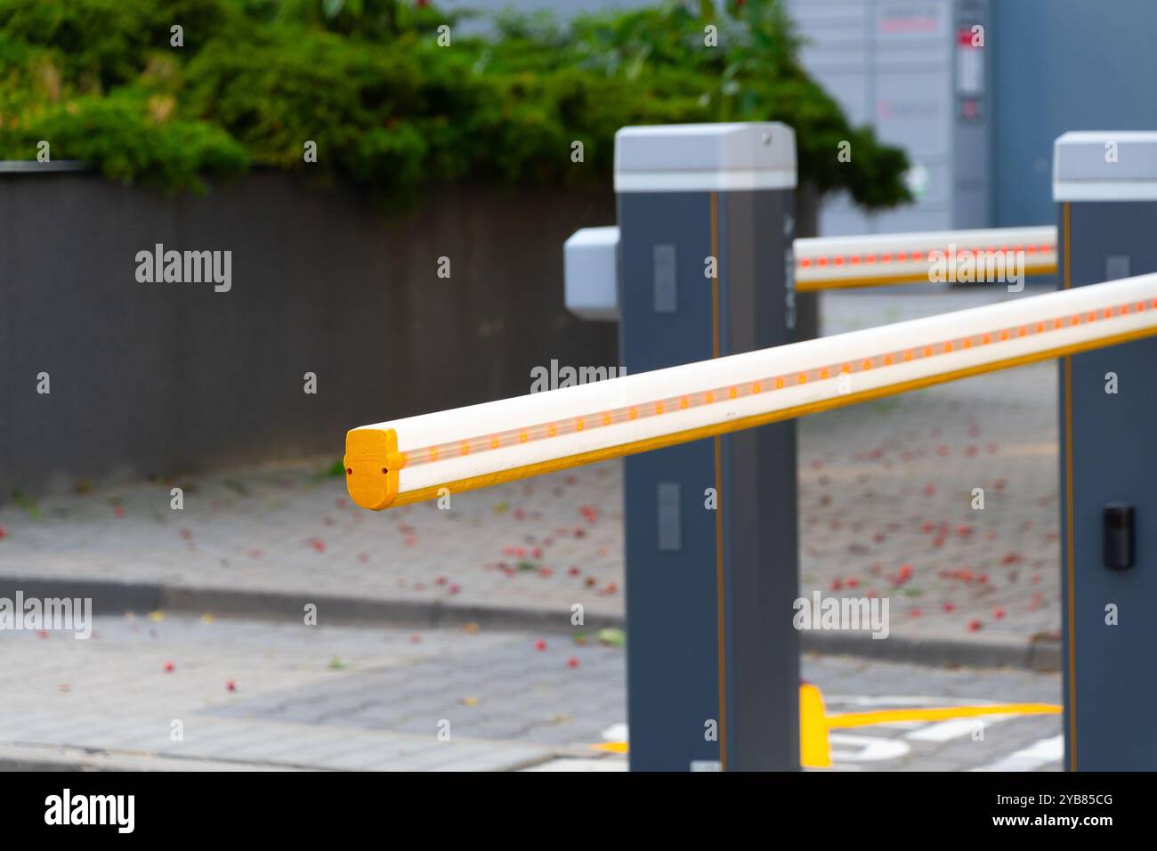 boom gate at the entrance to a protected area. A bar, post, pole, beam ...