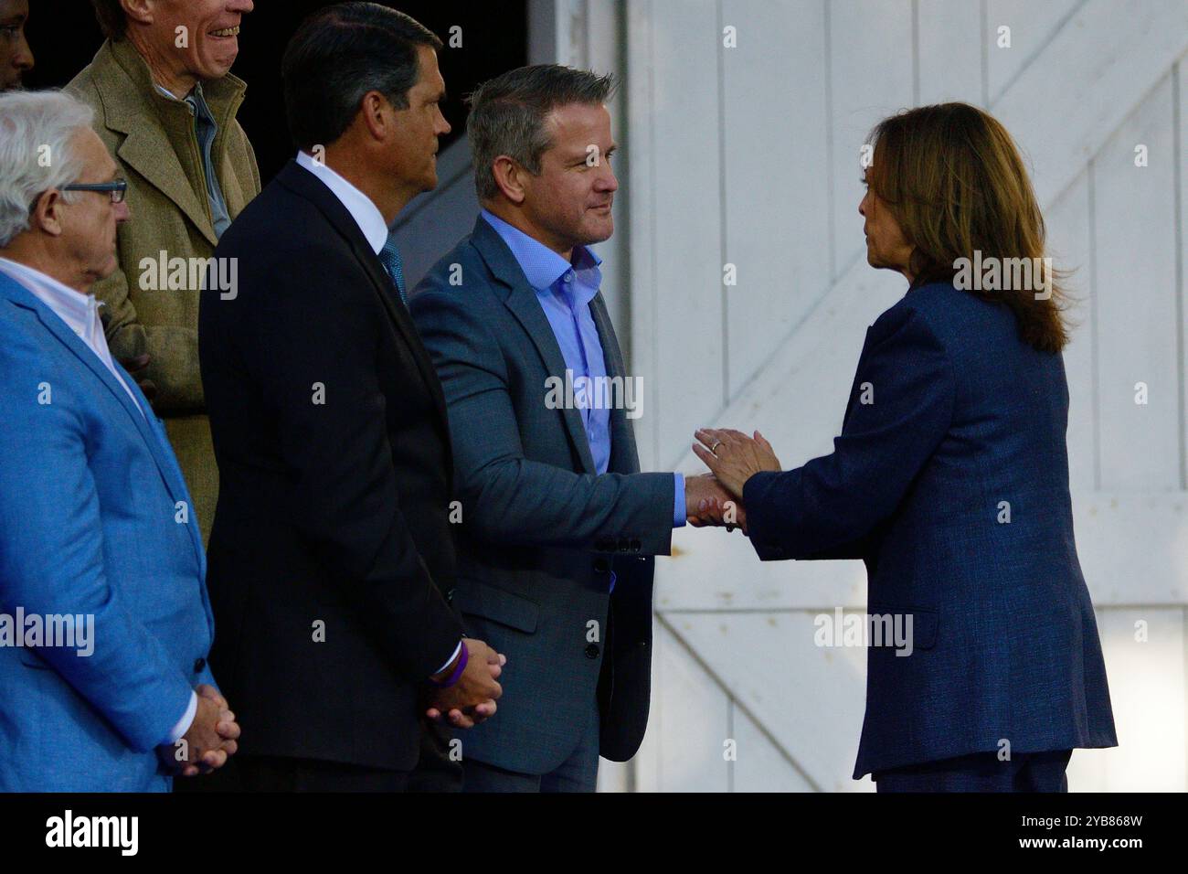 Adam Kinzinger and Kamala Harris during an October 16, 2024 campaign ...