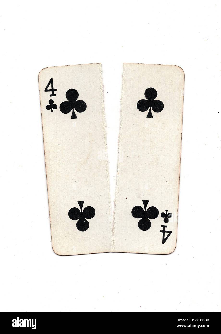 A vintage playing card torn in half from top to bottom on a white ...