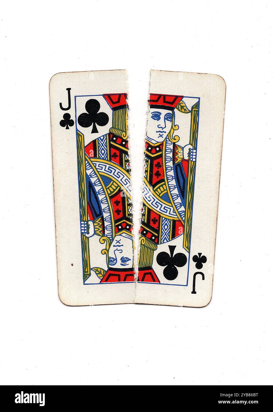 A vintage playing card torn in half from top to bottom on a white ...