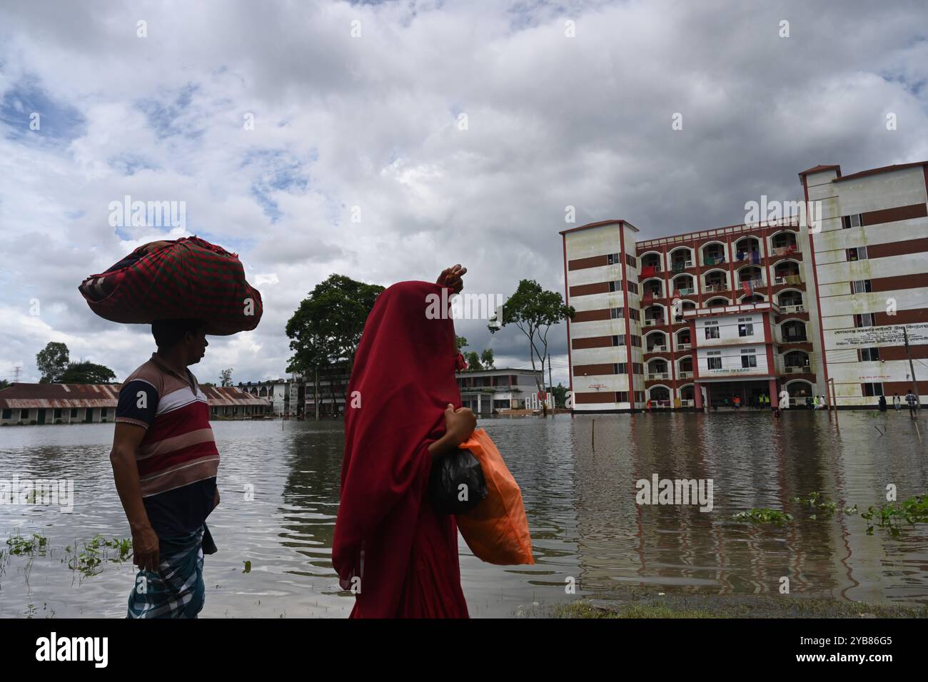 Flood affected peoples are take shelter at a school building in Feni ...